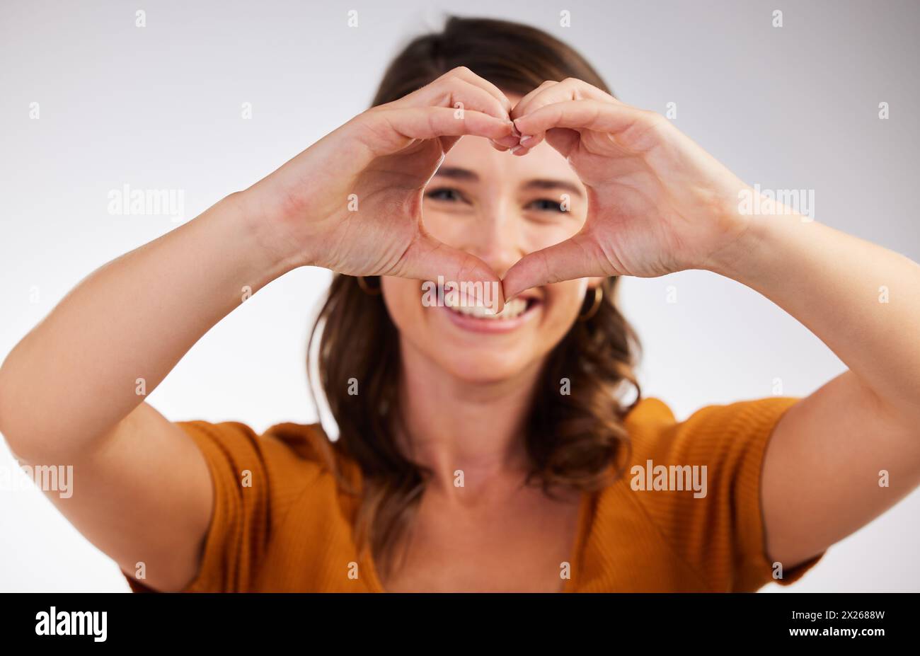Happy woman, portrait and heart hands with love for romance, care or ...