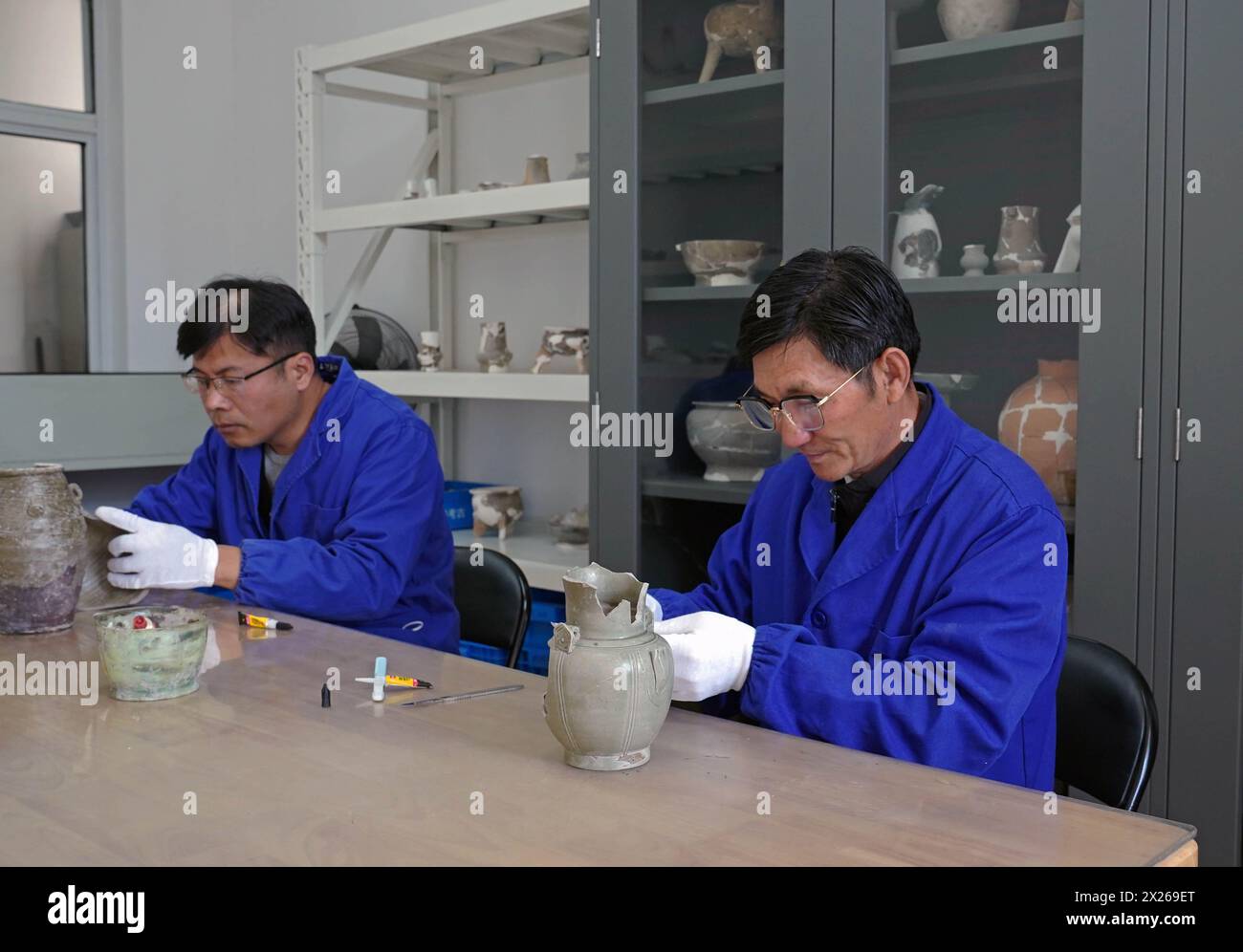 Beijing, China. 10th Apr, 2024. Staff members restore relics at an ...