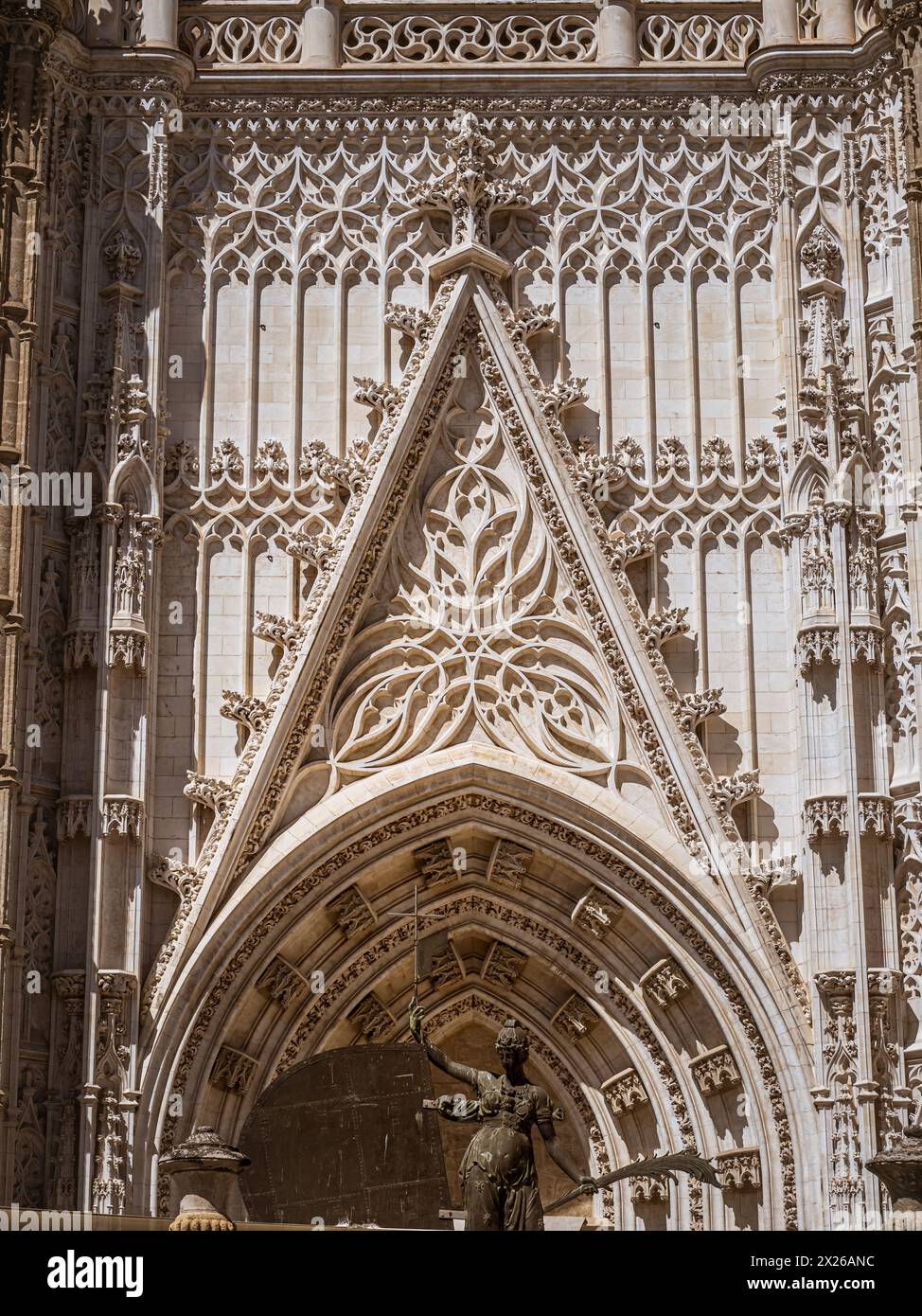 Seville cathedral gate and statues of saints. The Assumption Gate of ...