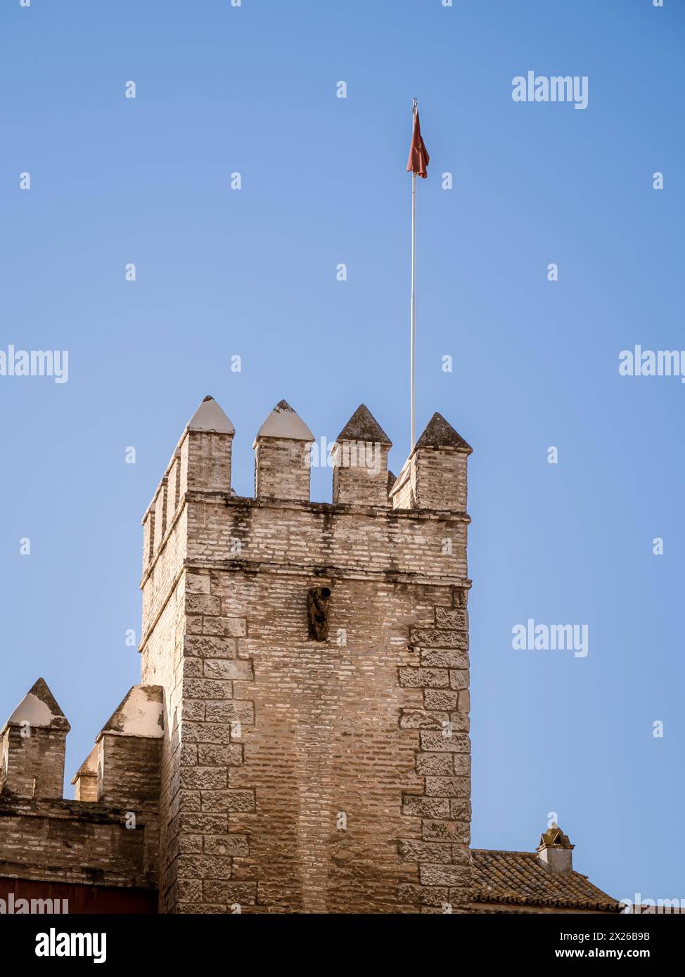A bastion tower on the walls of the Real Alcazar in Seville Stock Photo ...