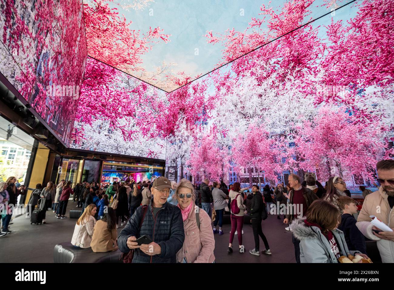 London, UK. 20 April 2024. The public watches digital screens ...