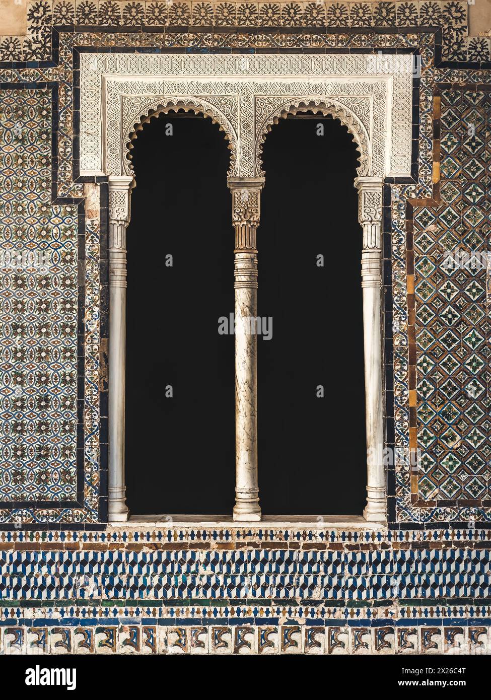 A classic Arabic Andalusian window framed with ornamental carvings and ...