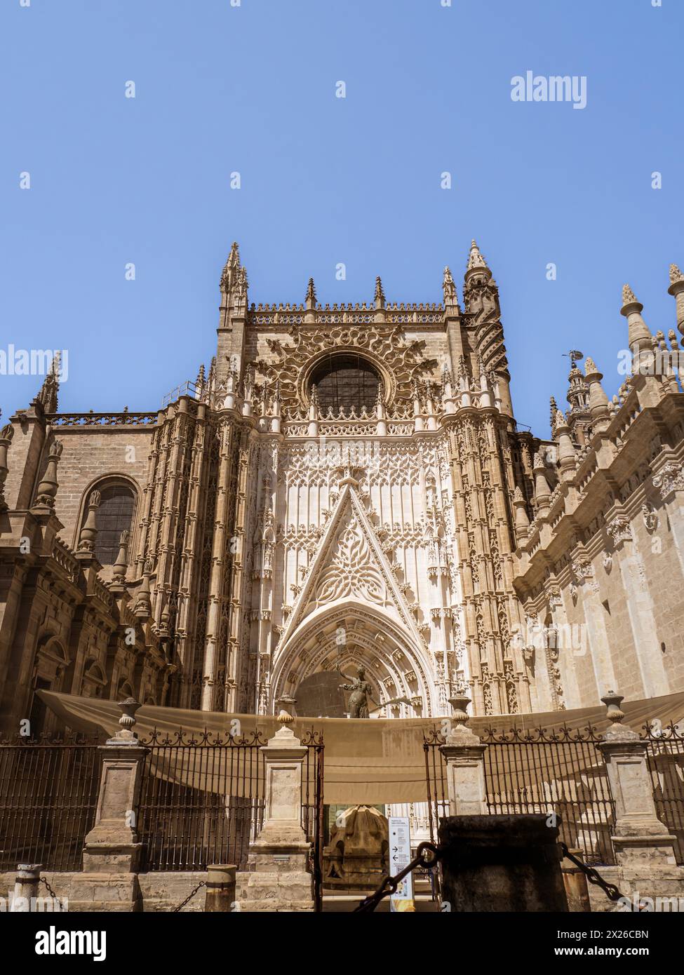 Seville cathedral gate and statues of saints. The Assumption Gate of ...