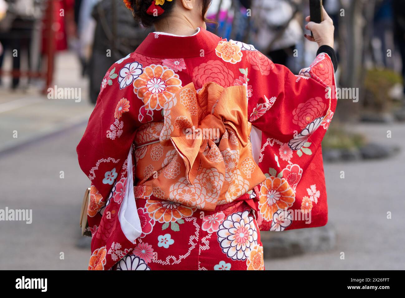 Young girl wearing Japanese kimono standing in front of Sensoji Temple ...