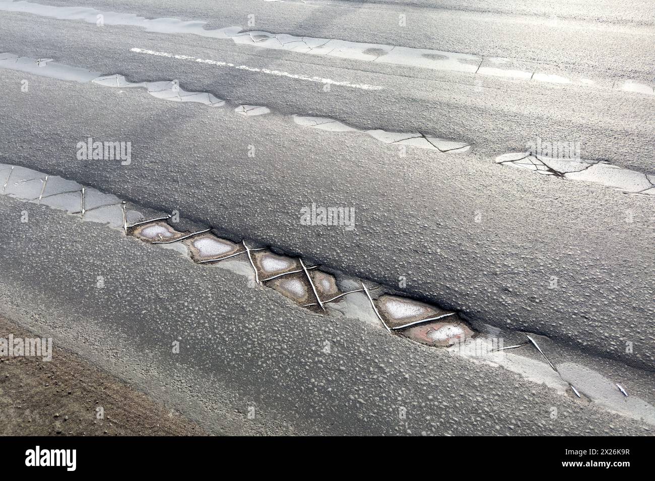 Rutting on poor asphalt road on bridge in the city, low-quality asphalt ...