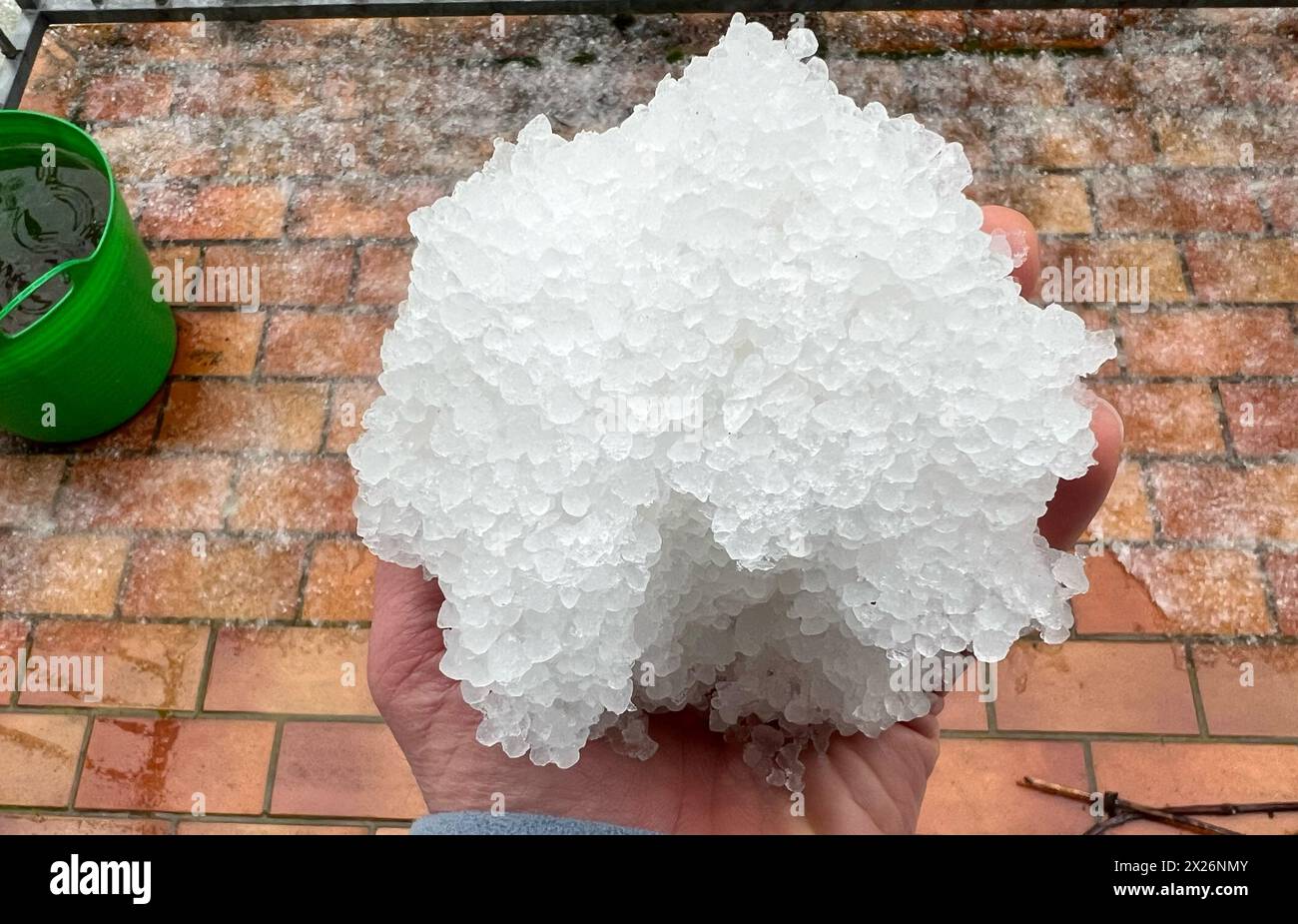 20 April 2024, Hesse, Frankfurt/Main: A hand holds white frozen pellets ...