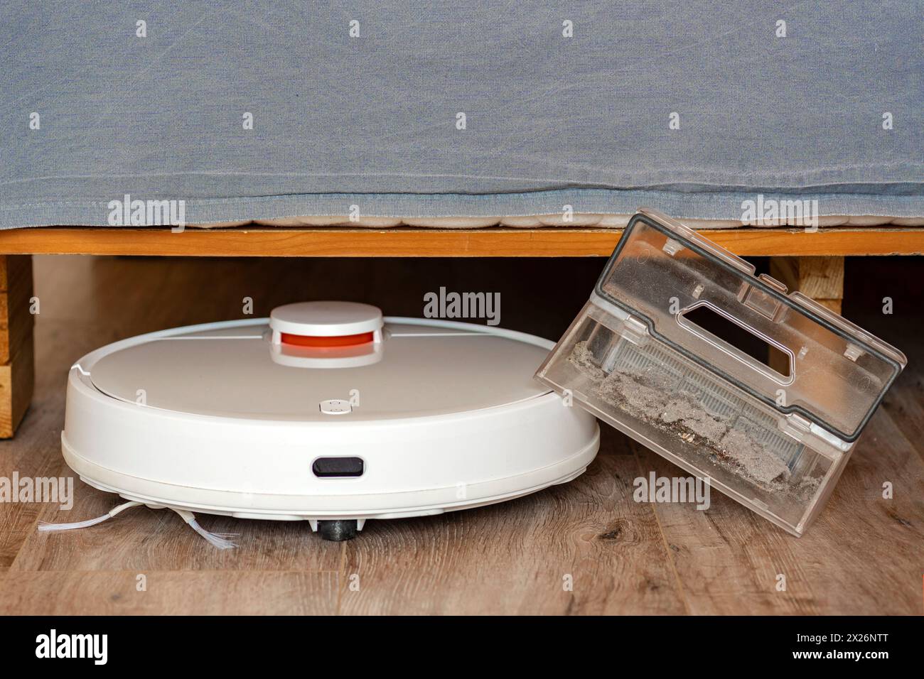 White robot vacuum cleaner.Garbage container. close-up. Robot vacuum ...