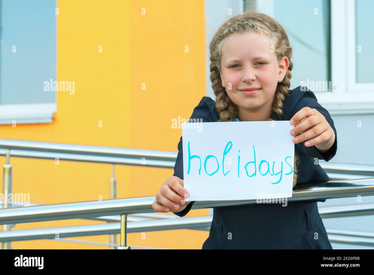 happy girl holding paper with the words holidays. Concept School ...