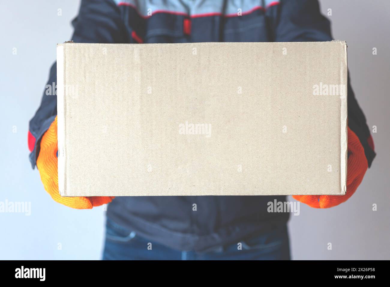 delivery man holding package. Courier holding box. man carrying ...