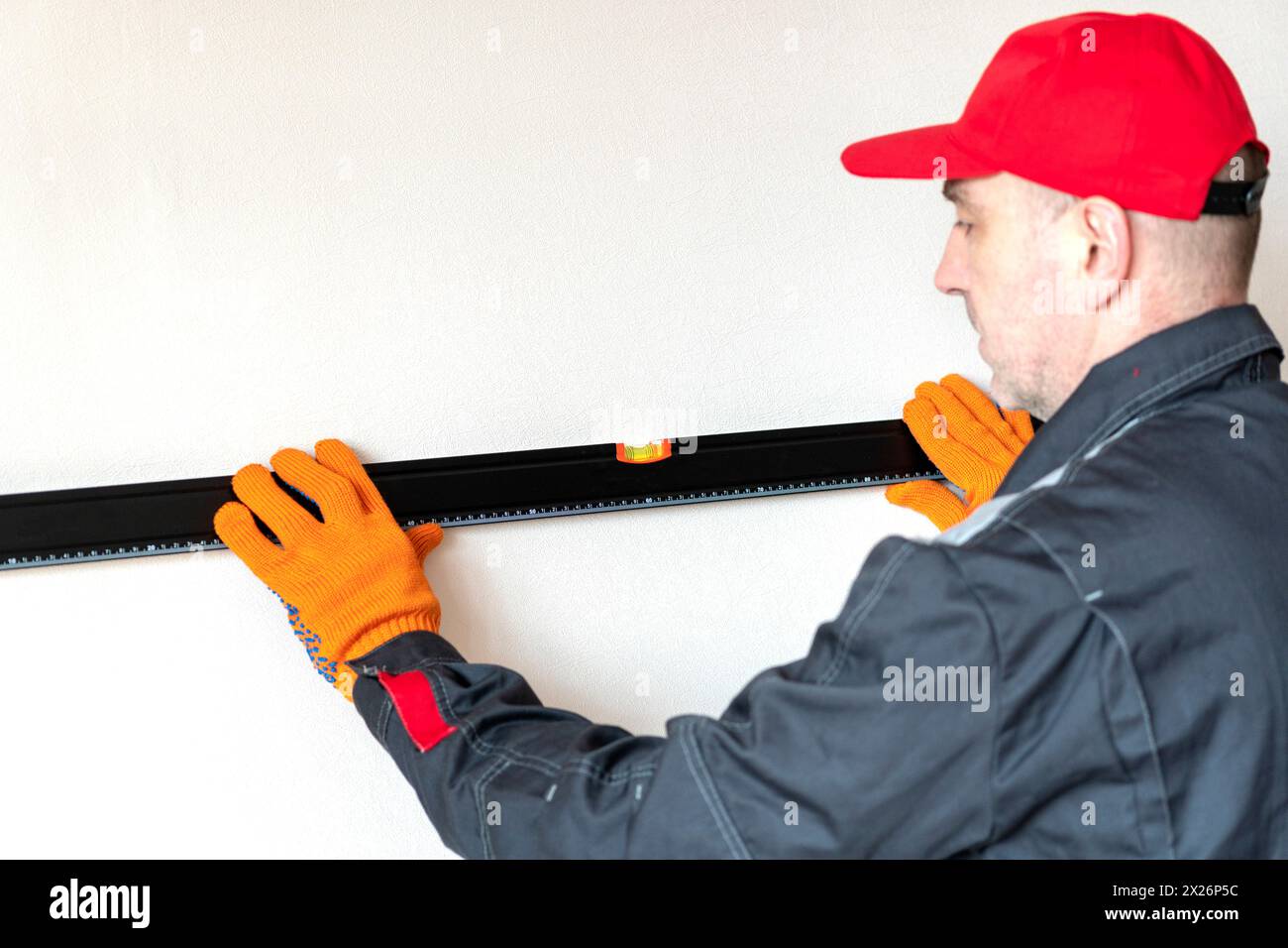 Worker with bubble level. measuring with bubble level.Measurement ...