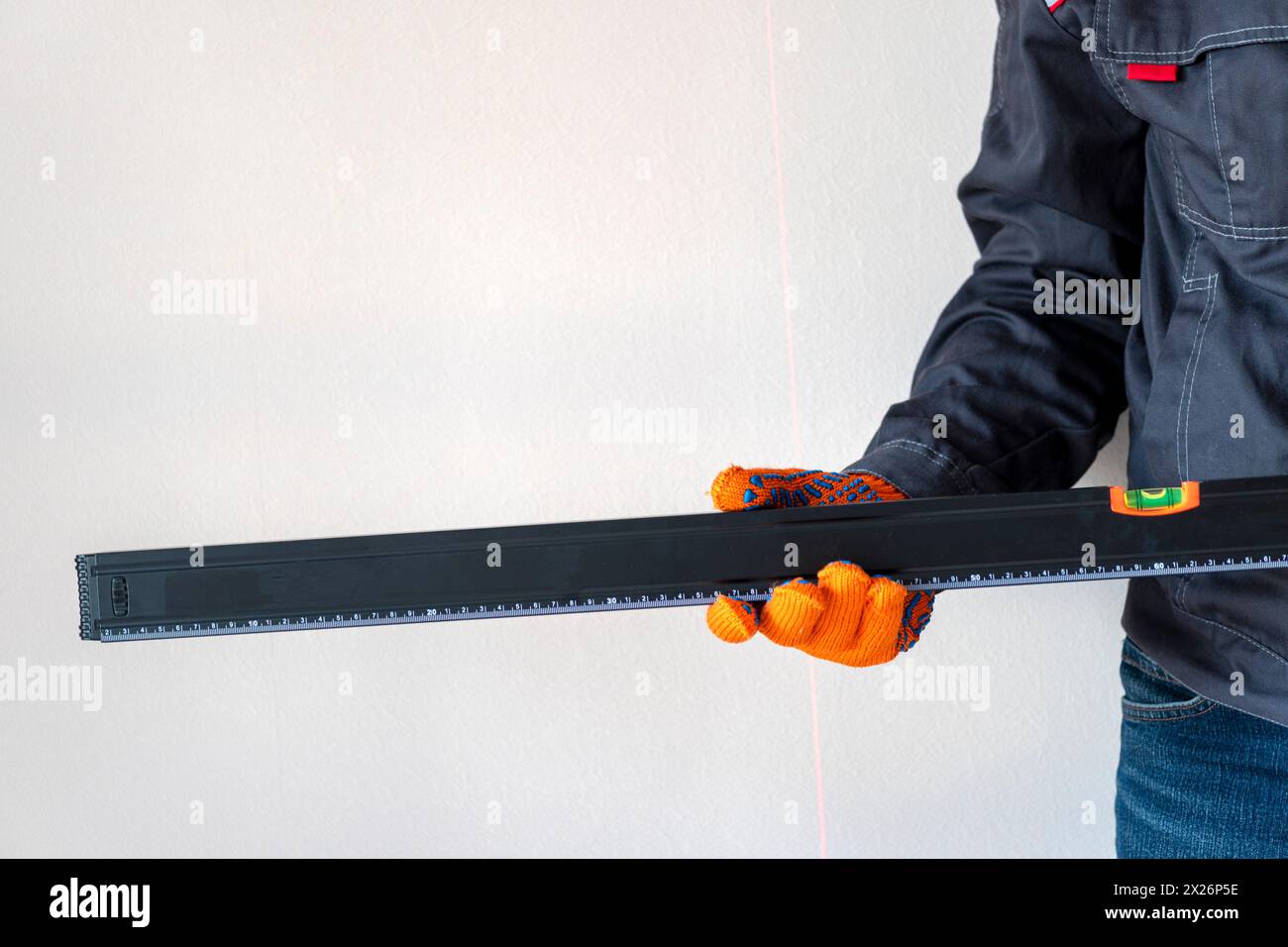 Worker's hands with bubble level. measuring with bubble level ...