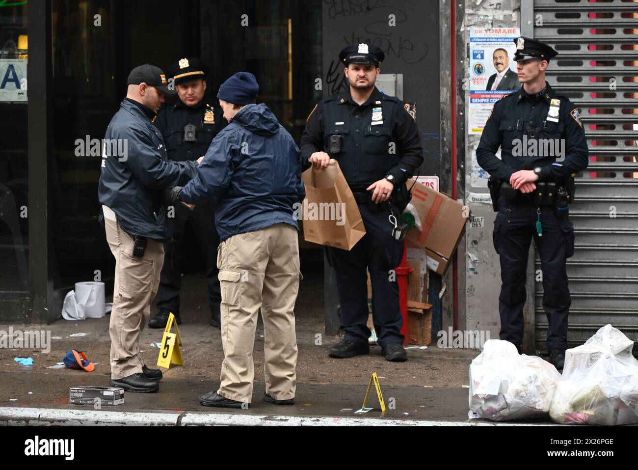 Police officers and the NYPD crime scene unit collect evidence. Man ...