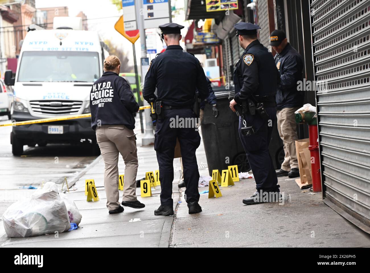 Police officers and the NYPD crime scene unit collect evidence. Man ...