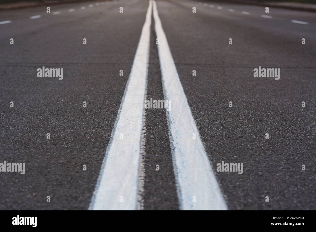 The asphalted road with two continuous white strips. The highway with a ...