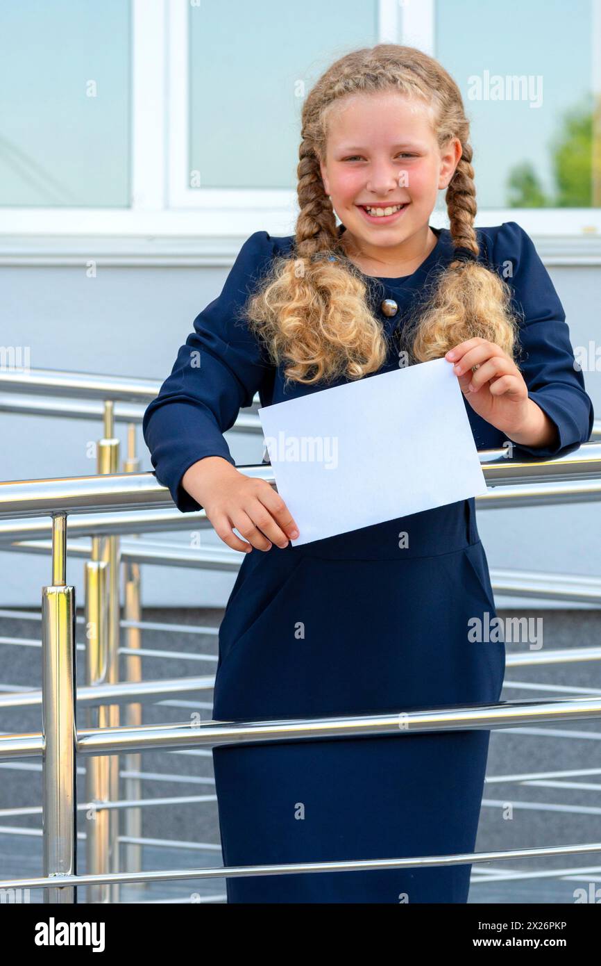 girl holding paper with the words . Concept School holidays,graduation ...