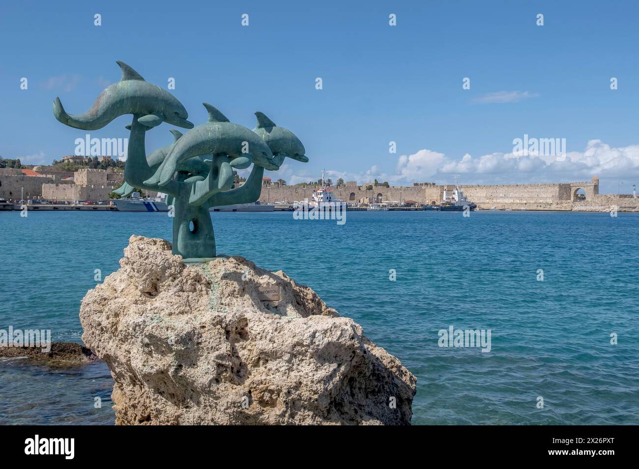 Dolphin statue in Kolona harbour, Rhodes, Dodecanese archipelago, Greek ...
