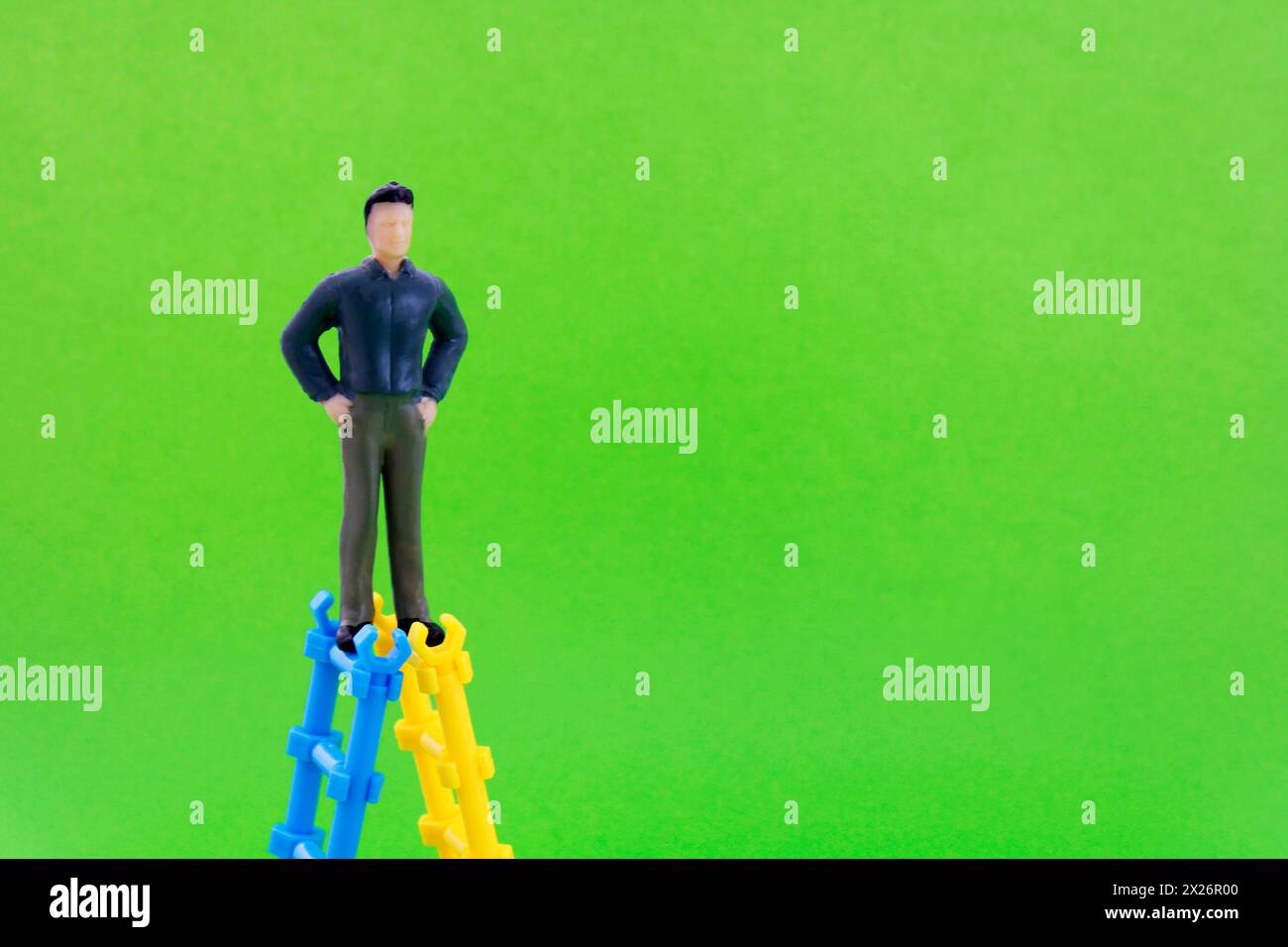 Man balancing on two ladders leaning against each other Stock Photo - Alamy