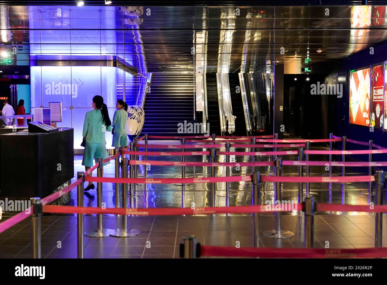 An interior with an empty queue demarcated by red delineators and shiny ...