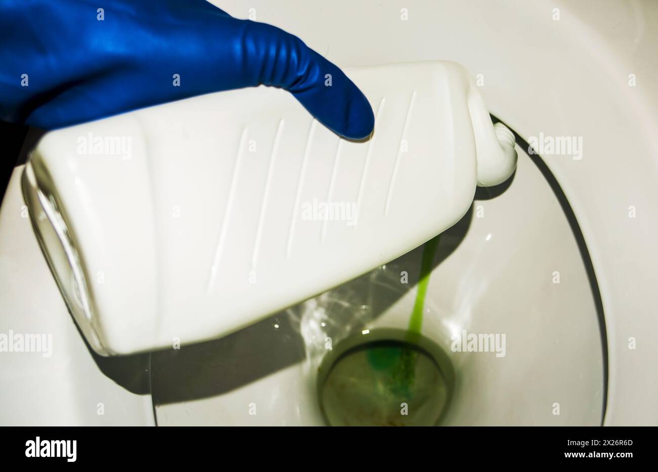 Process toilet disinfectant. Close-up. Hand holds a bottle. Purity in a ...