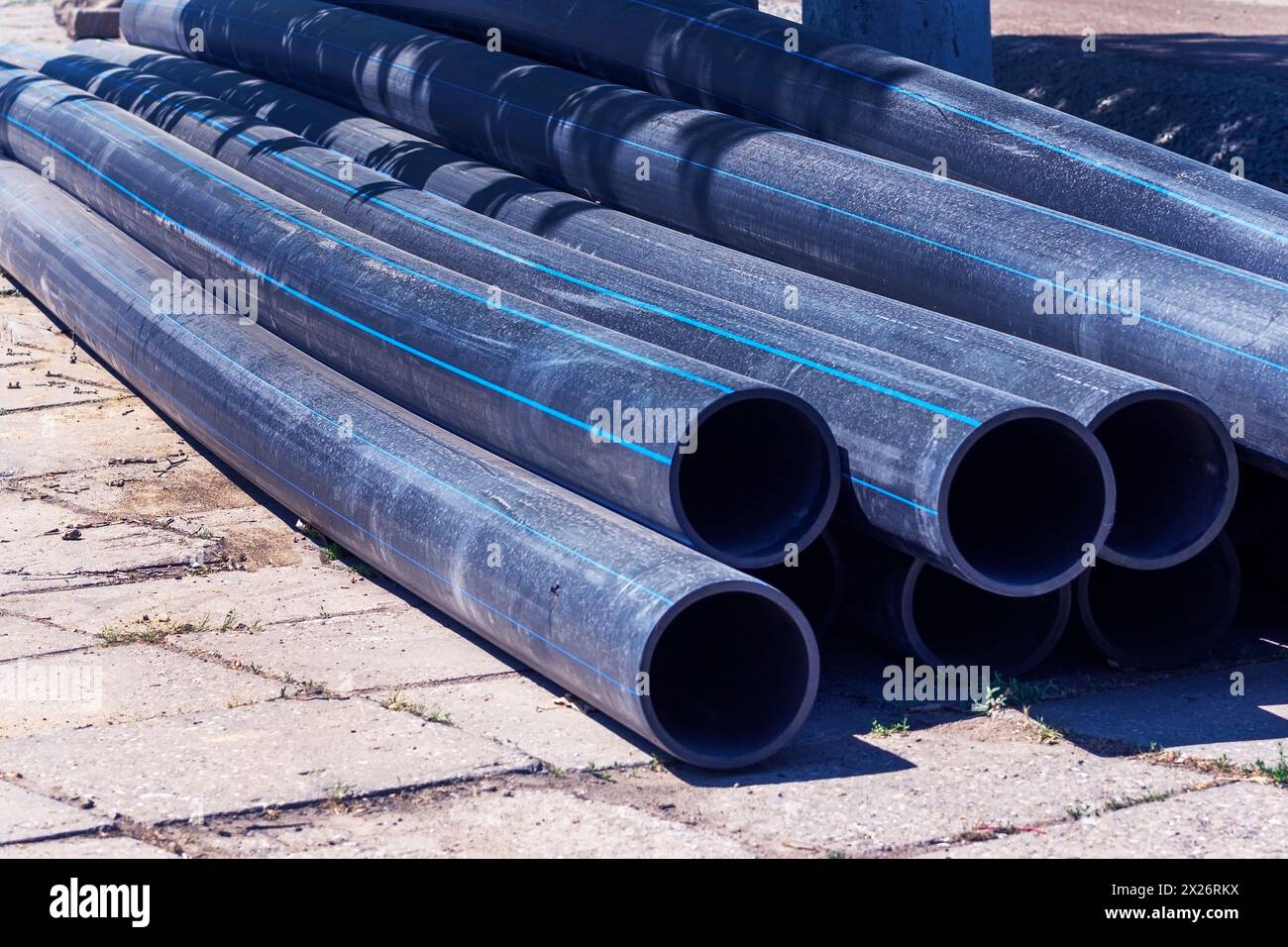 Plastic main black pipes. A heap of polyethylene pipes for a water ...