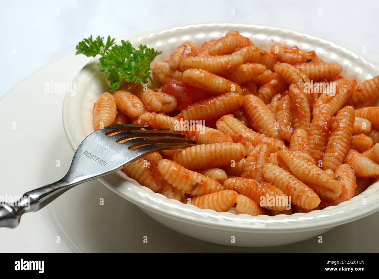 Malloreddus, Sardinian gnocchetti with tomato sauce in a plate ...
