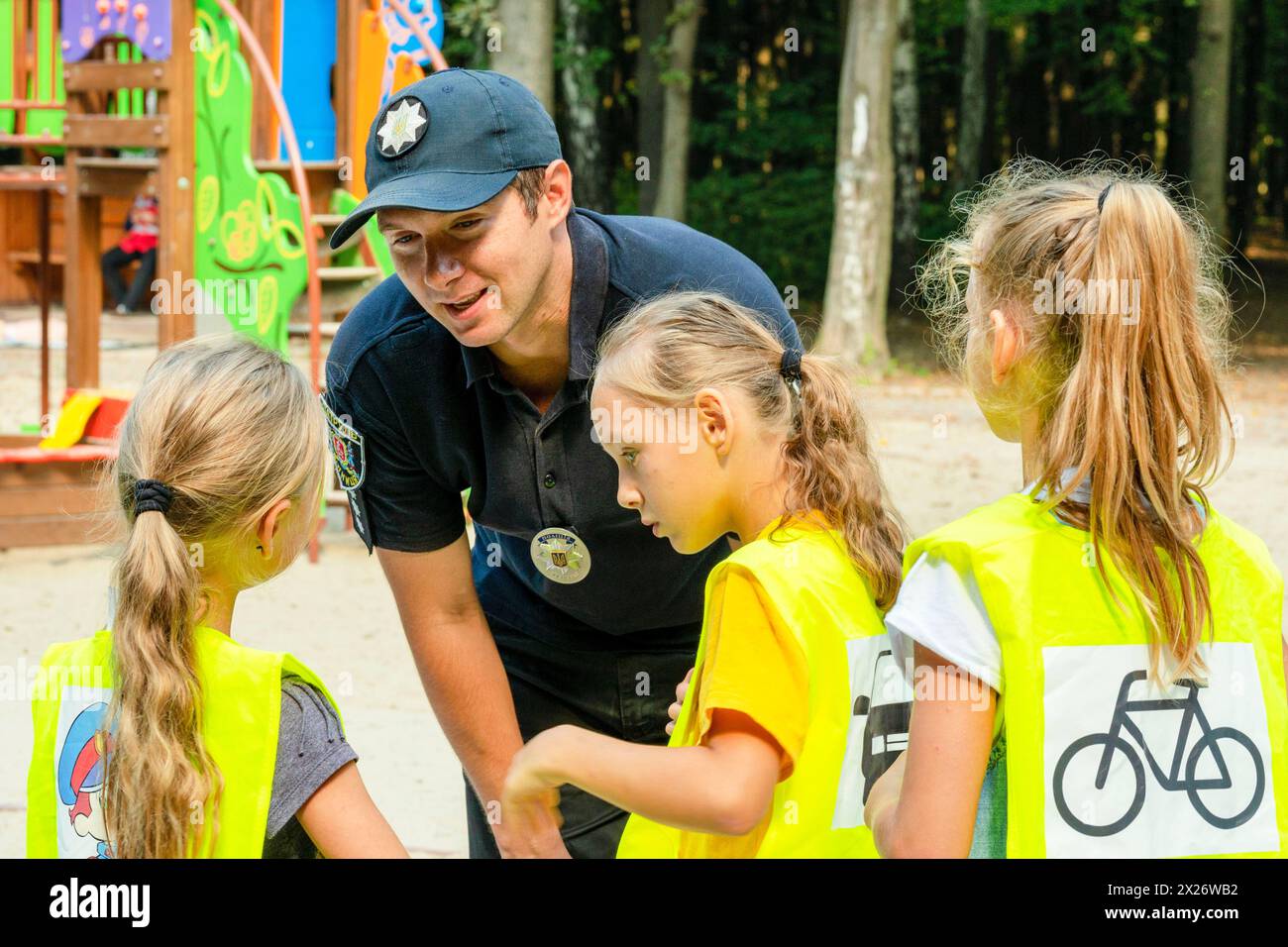 The police officer explains traffic regulations to girls. The cop talks ...