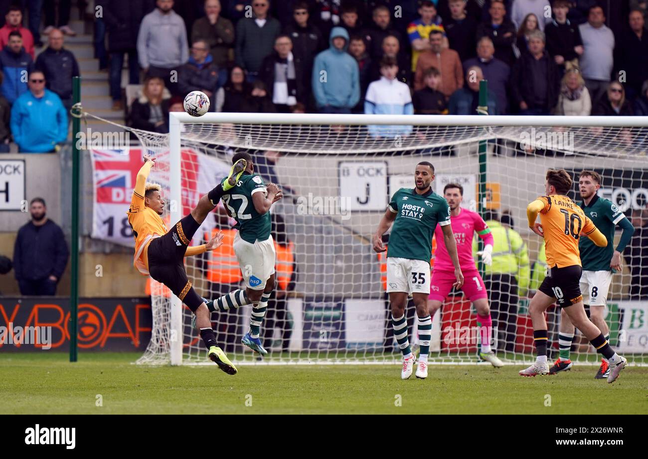 Cambridge United's Lyle Taylor attempts an overhead kick and connects ...