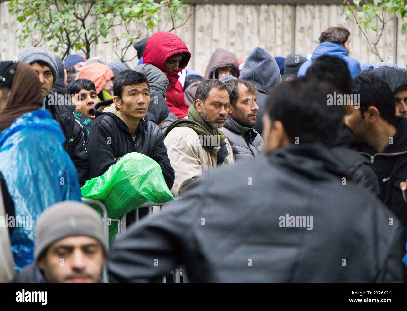 Syrian refugees wait for their registration in cold and wet weather at ...