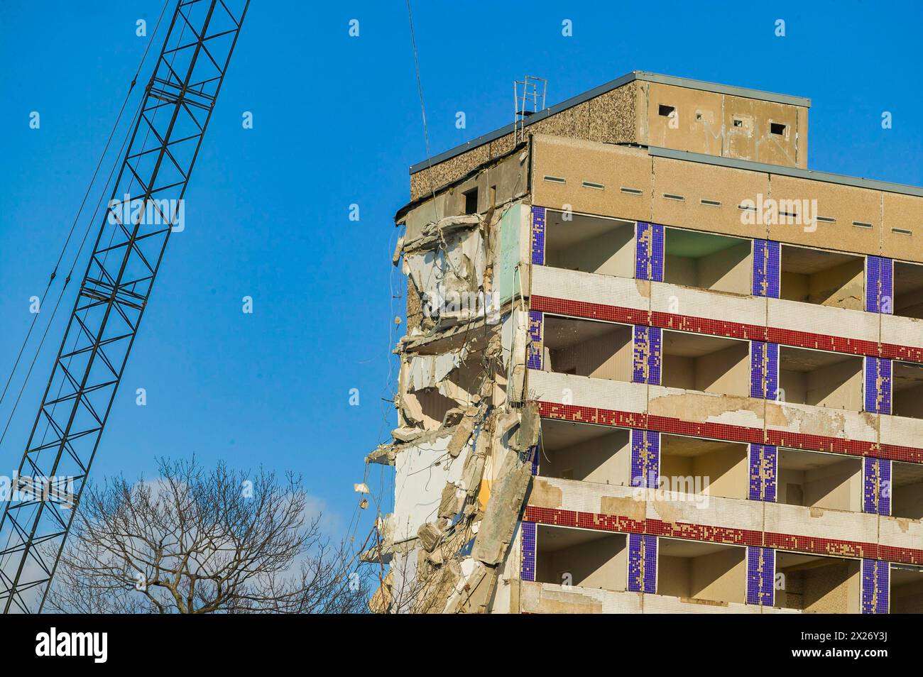 A multi-storey building is demolished under a clear blue sky Stock ...