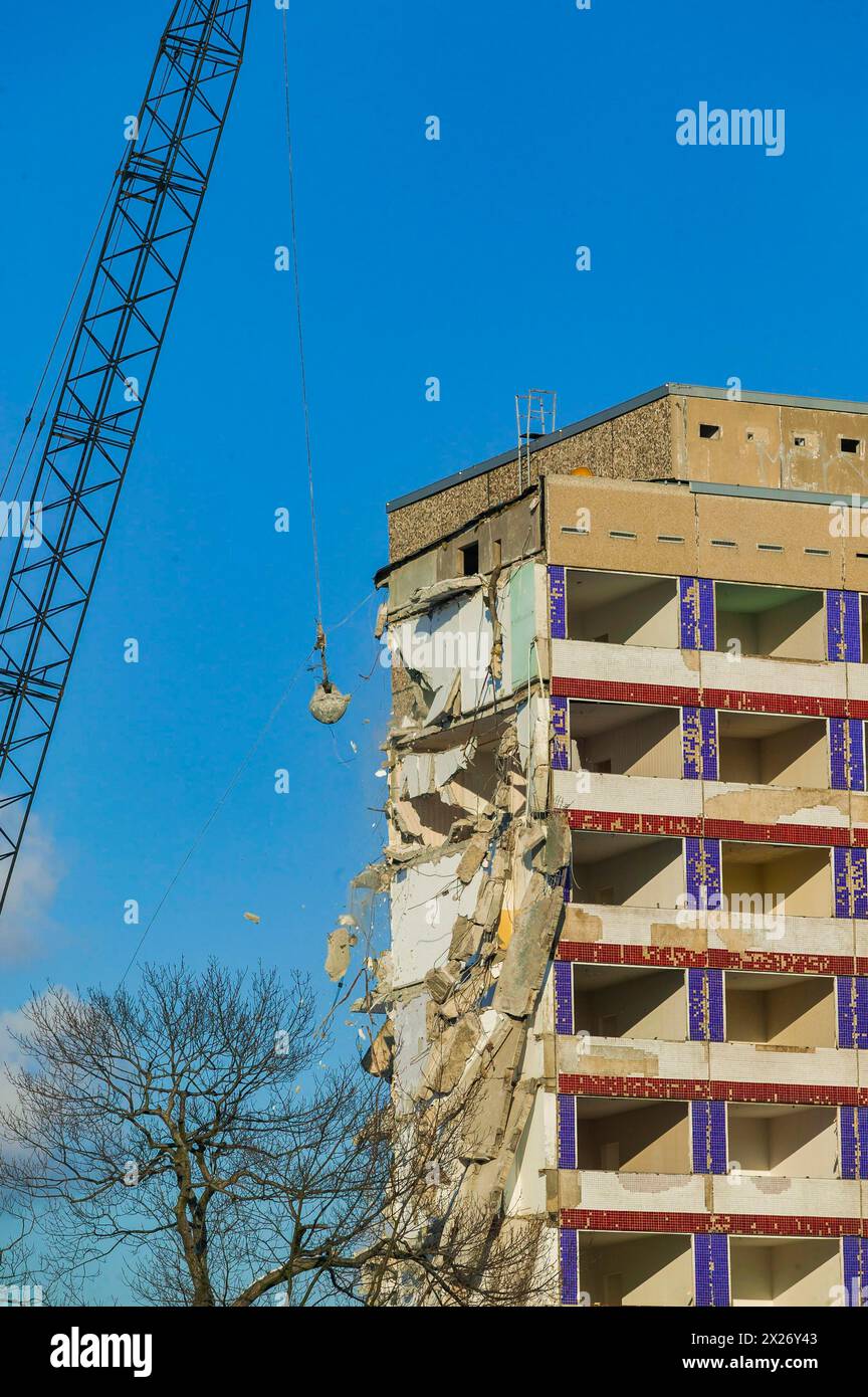 A multi-storey building is demolished under a clear blue sky Stock ...