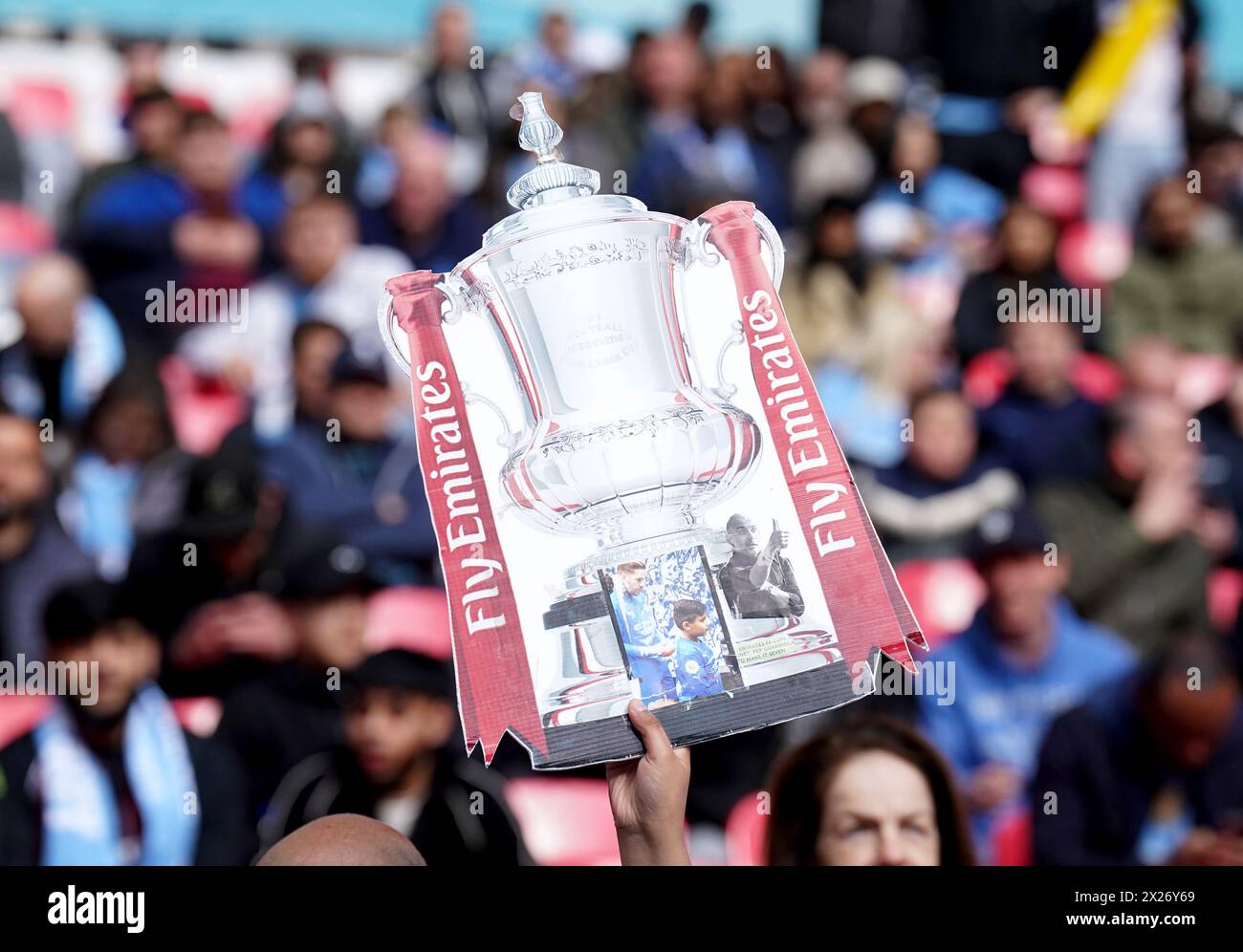 Fans in the stands hold up an FA Cup trophy banner ahead of the ...
