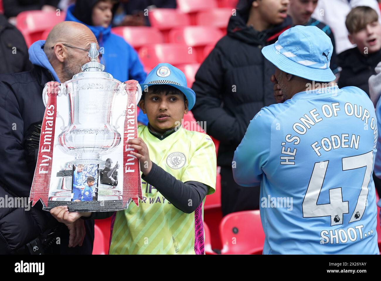 Fans in the stands hold up an FA Cup trophy banner ahead of the ...