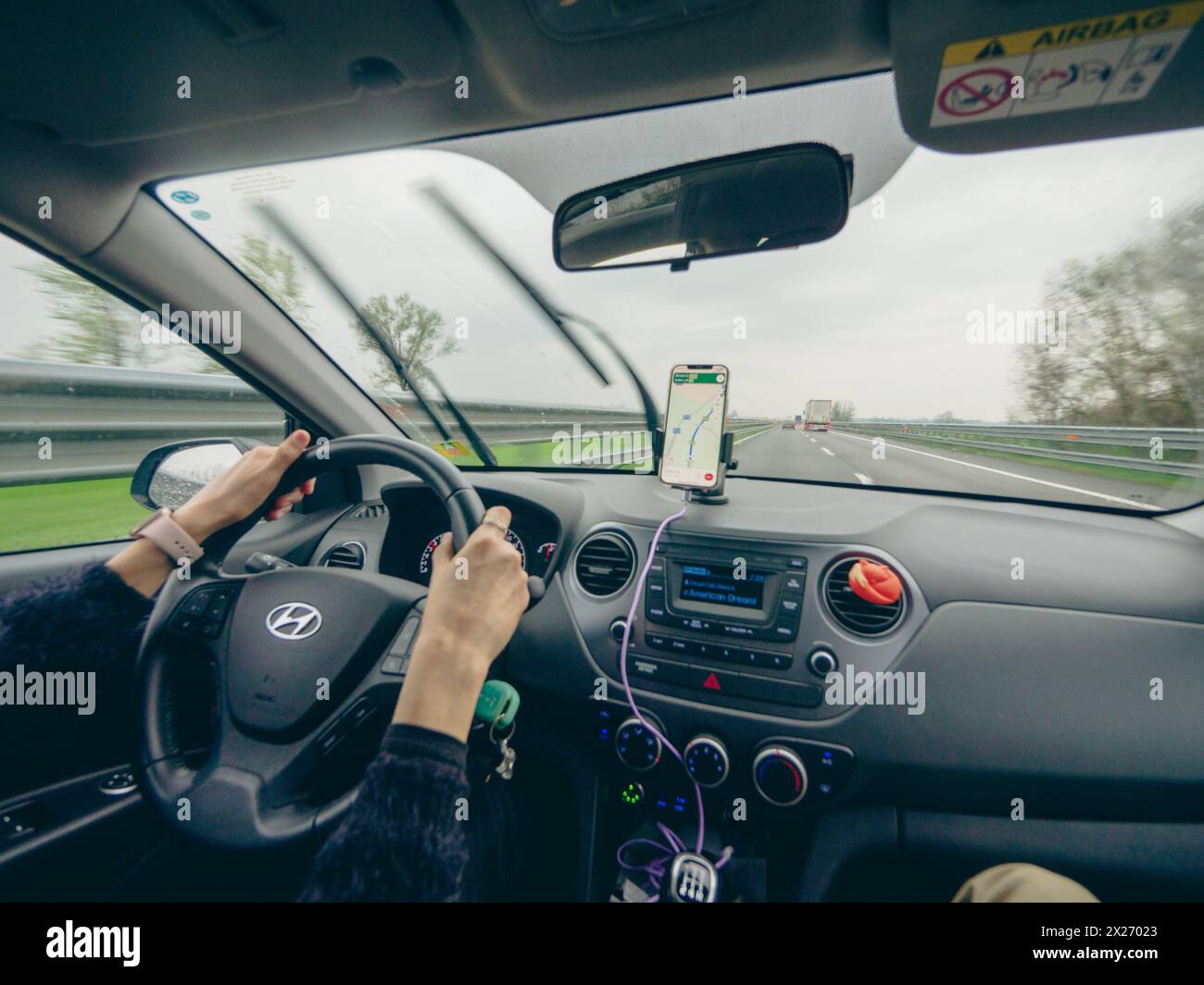 Milan, Italy - April 26th 2023 View from inside a car with a smartphone ...