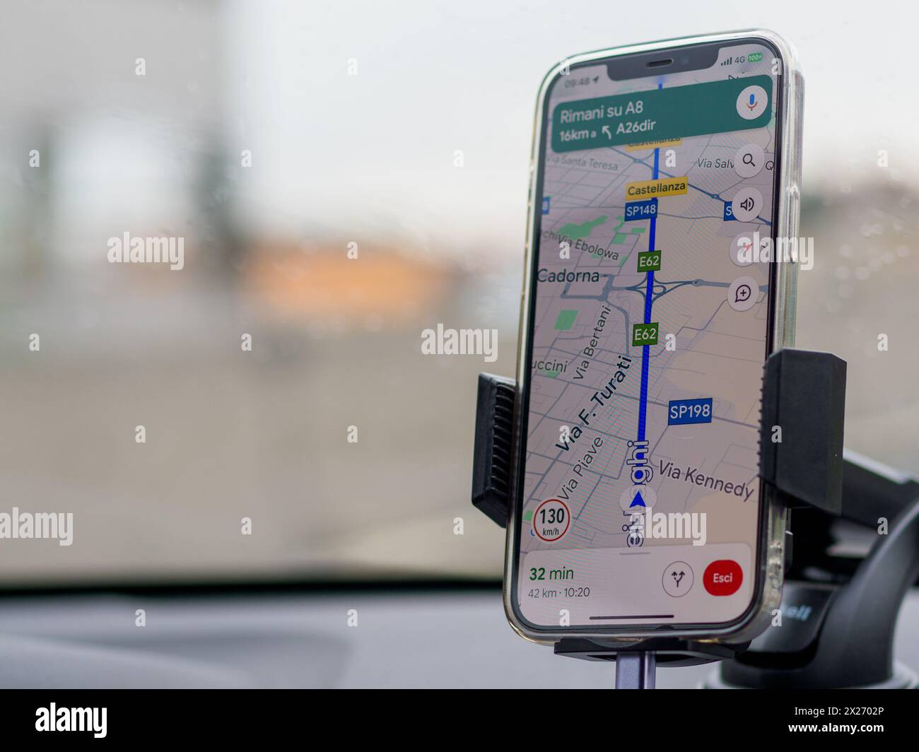 Milan, Italy - April 26th 2023 Smartphone displaying GPS navigation mounted on a car's dashboard ...