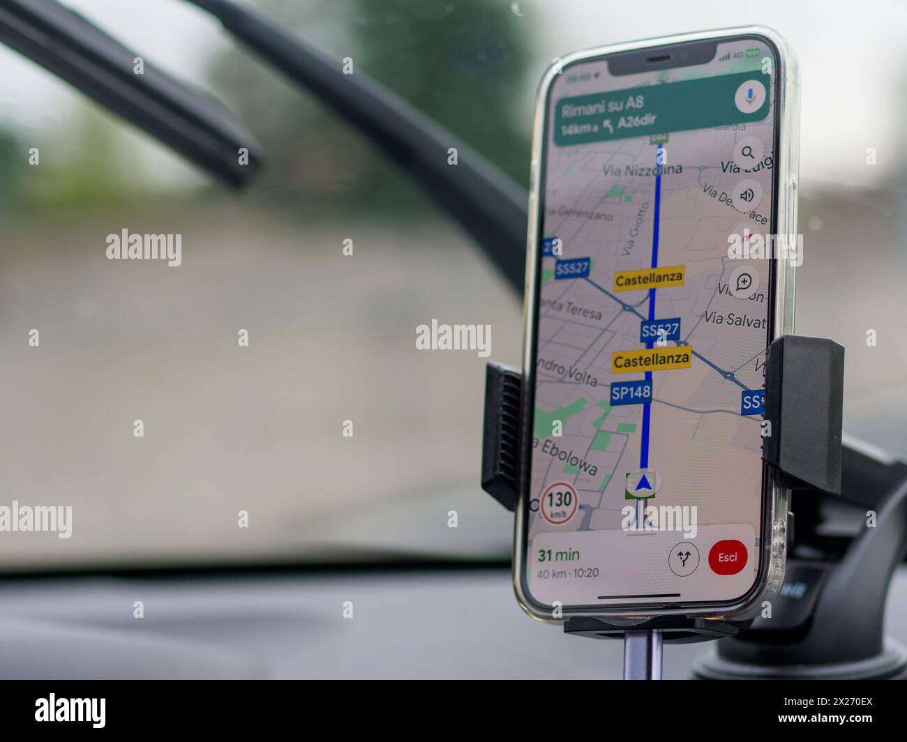 Milan, Italy - April 26th 2023 Smartphone displaying GPS navigation mounted on a car's dashboard ...
