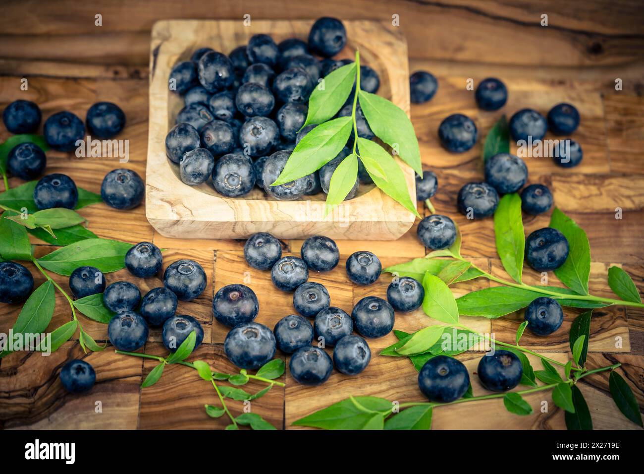 freshly picked blueberries on olive wood Stock Photo - Alamy