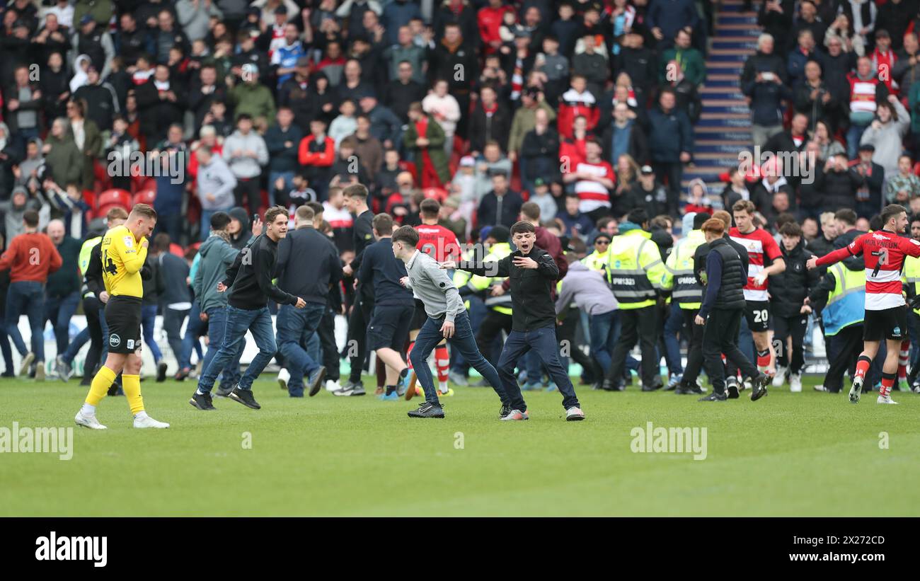 Doncaster Rovers' fans flock on to the pitch after their fourth goal ...