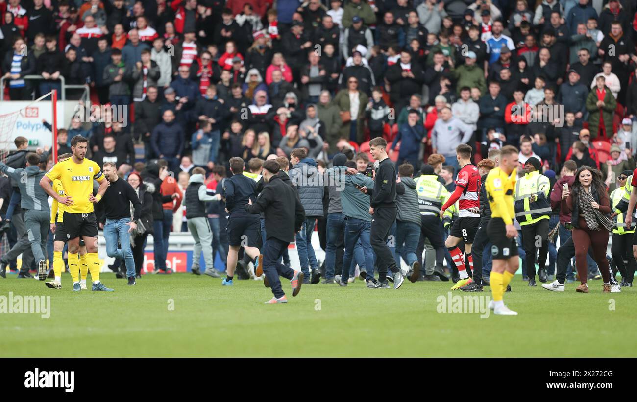 Doncaster Rovers' fans flock on to the pitch after their fourth goal ...