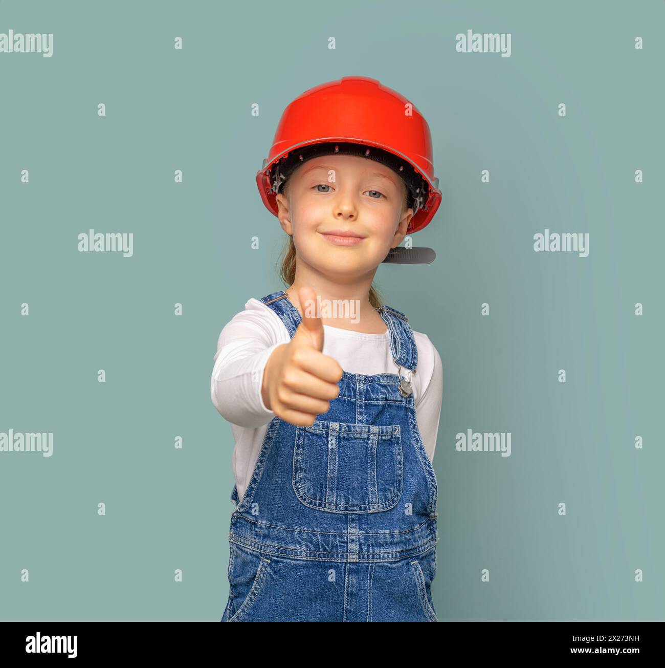 Little girl worker in a safety helmet with a tool Stock Photo - Alamy