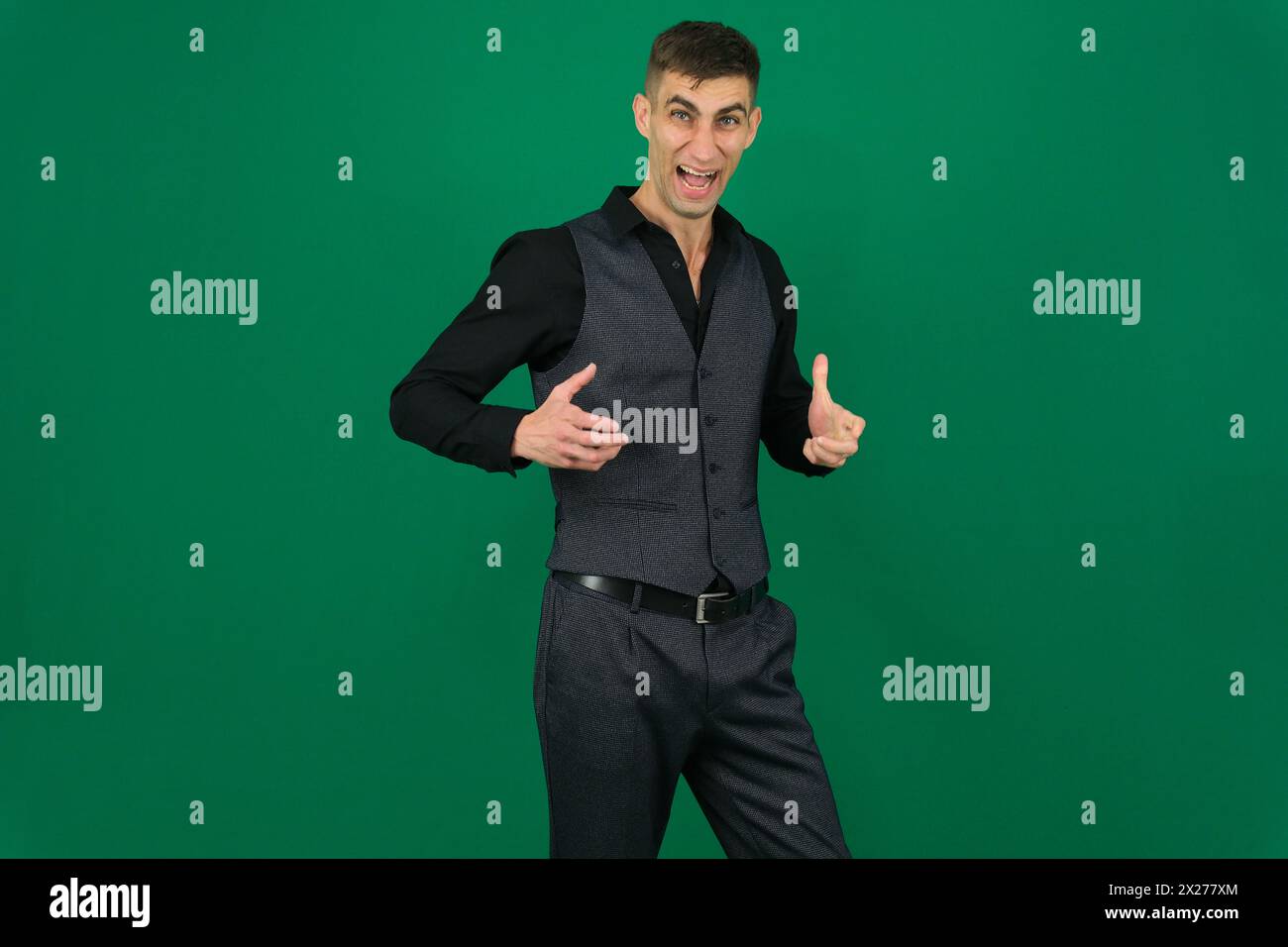 emotions of a handsome man guy on a green background chromakey close-up ...