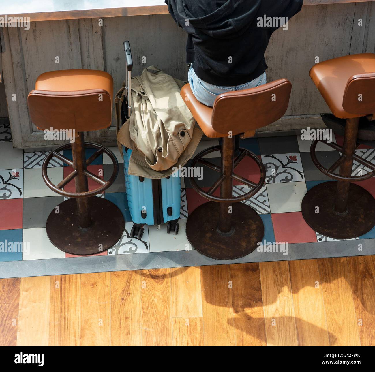 Passenger sitting at a Paris airport terminal bar drinking a beer, at ...