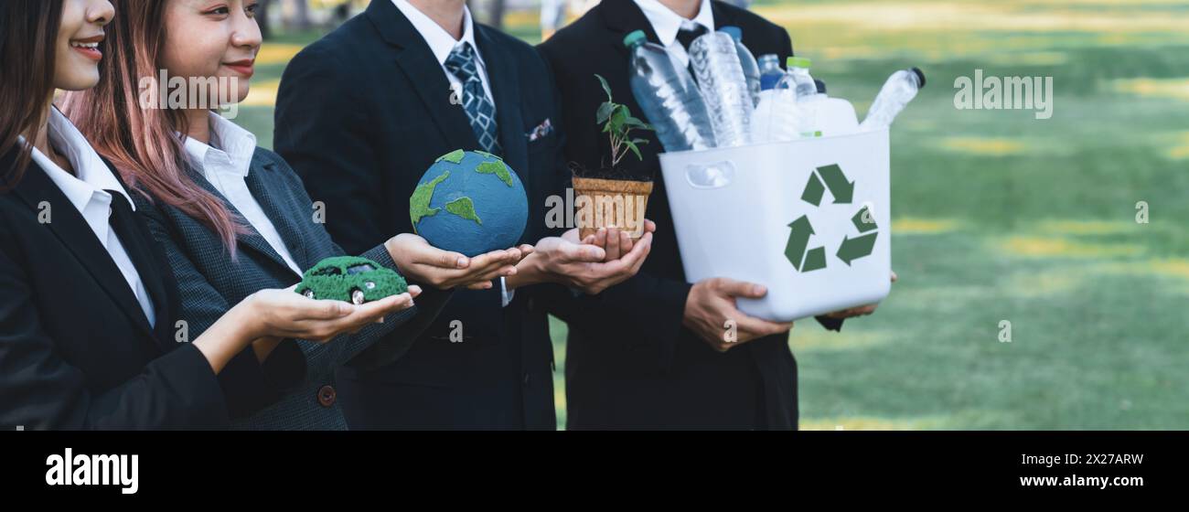 Group of businesspeople volunteer to promote Earth Day and ...