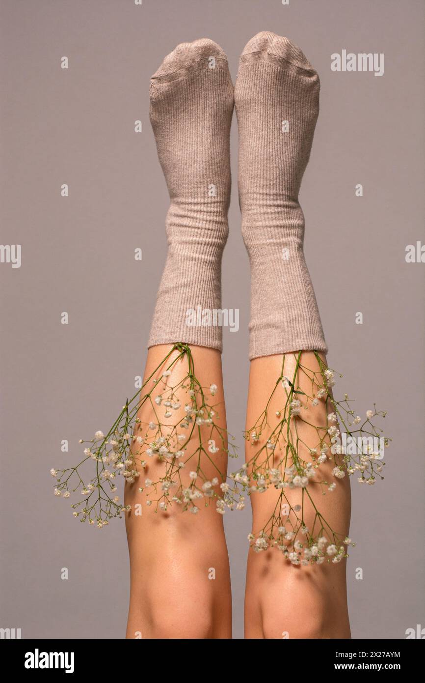 Beautiful women's legs with flowers, front view. Women's feet in socks ...