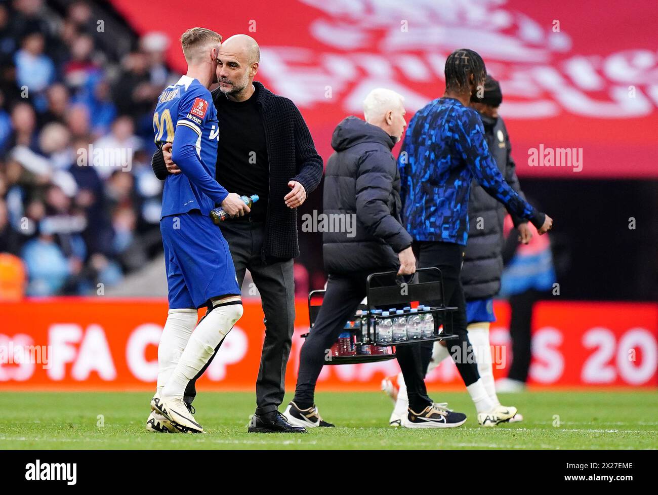 Manchester City manager Pep Guardiola embraces Chelsea's Cole Palmer (left) following the ...
