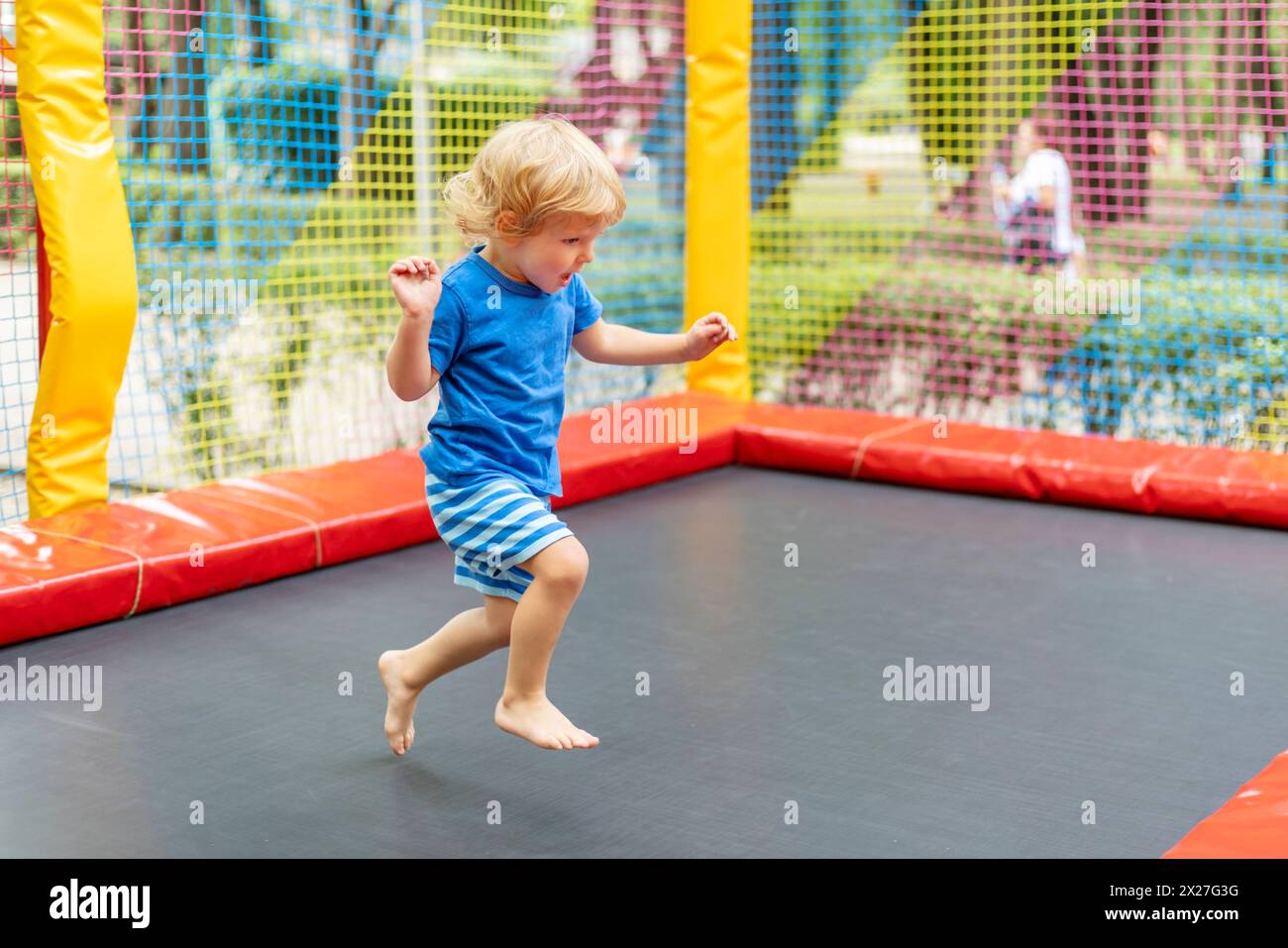 Toddler Jumping on Outdoor Trampoline Stock Photo - Alamy