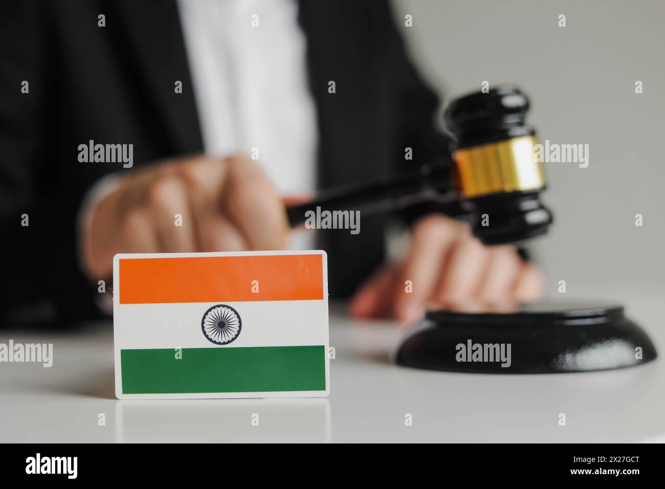 Judge's hand holding wooden gavel. Flag of India. Concept of Indian ...