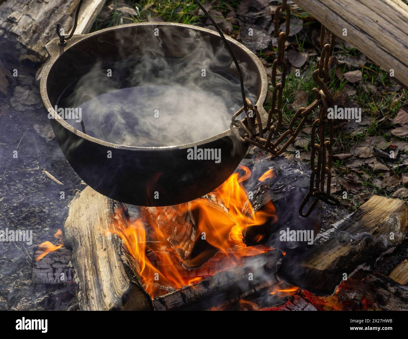 Pot On The Fire. Water boils in a cauldron over a fire Stock Photo - Alamy