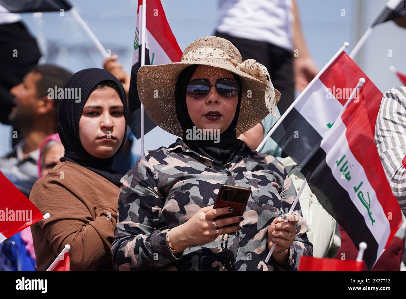 Mosul, Iraq. 20th Apr, 2024. Iraqi women hold Iraqi flags during Spring ...