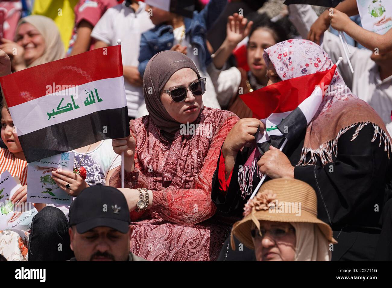 Mosul, Iraq. 20th Apr, 2024. Iraqi women hold Iraqi flags during Spring ...