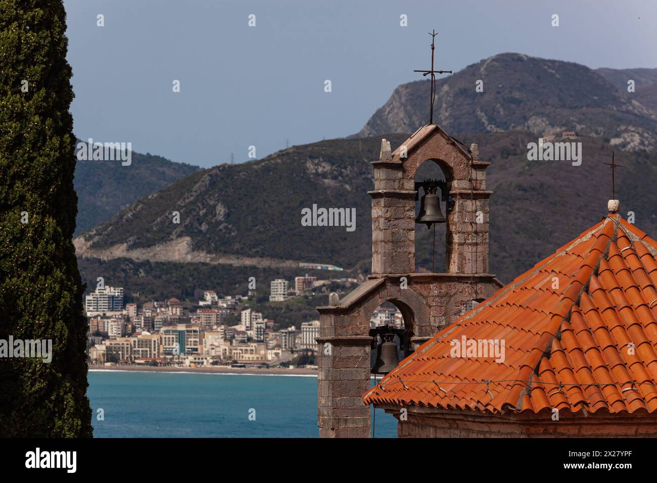 Bells on a stone monastery with an orange roof against a backdrop of ...
